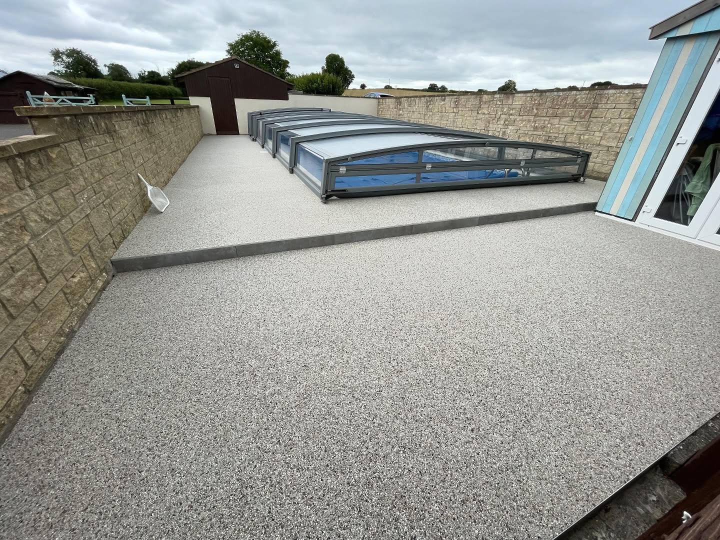 Resin-bound surface around a swimming pool – Landscape Works South West